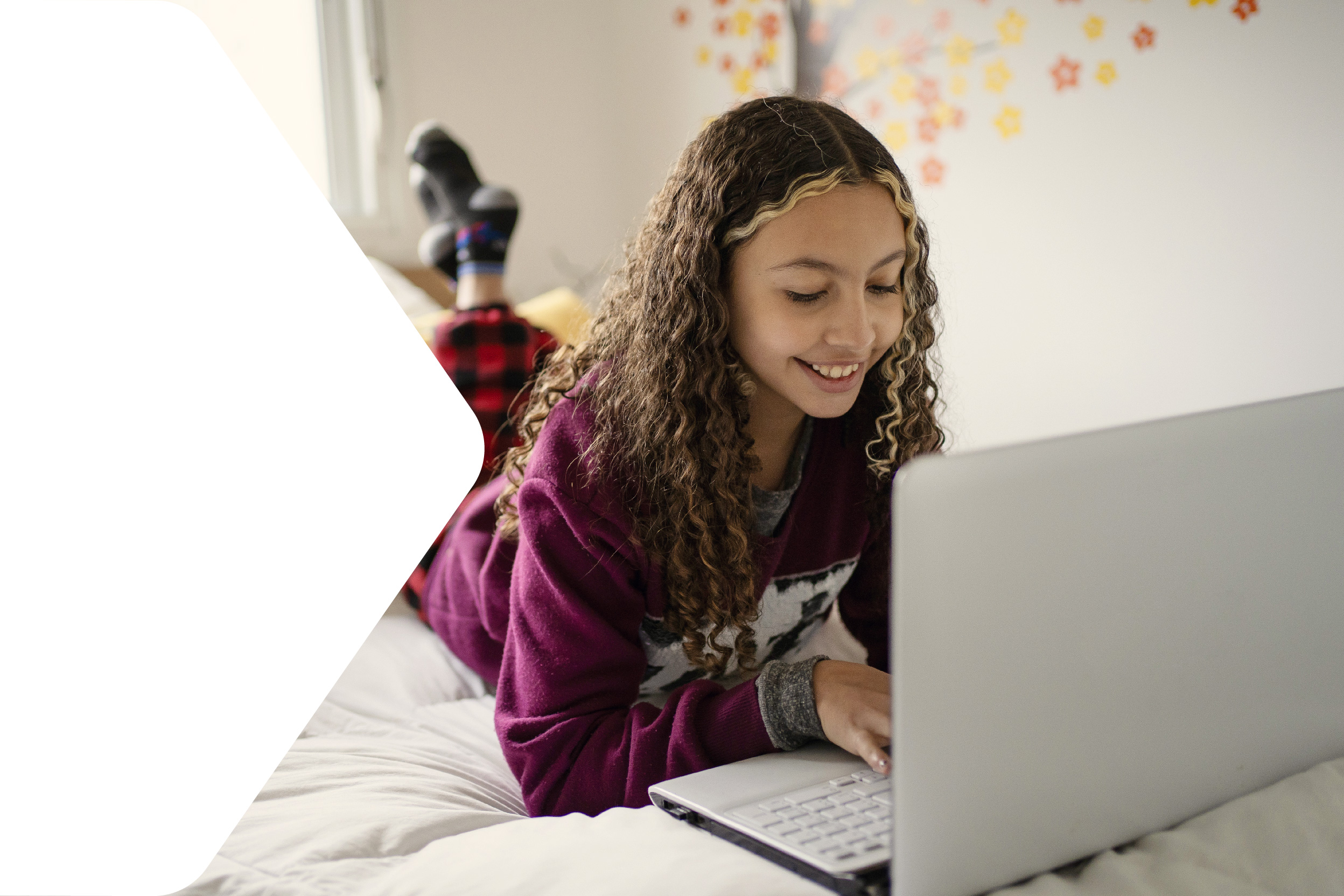 An image of a student typing on a laptop.